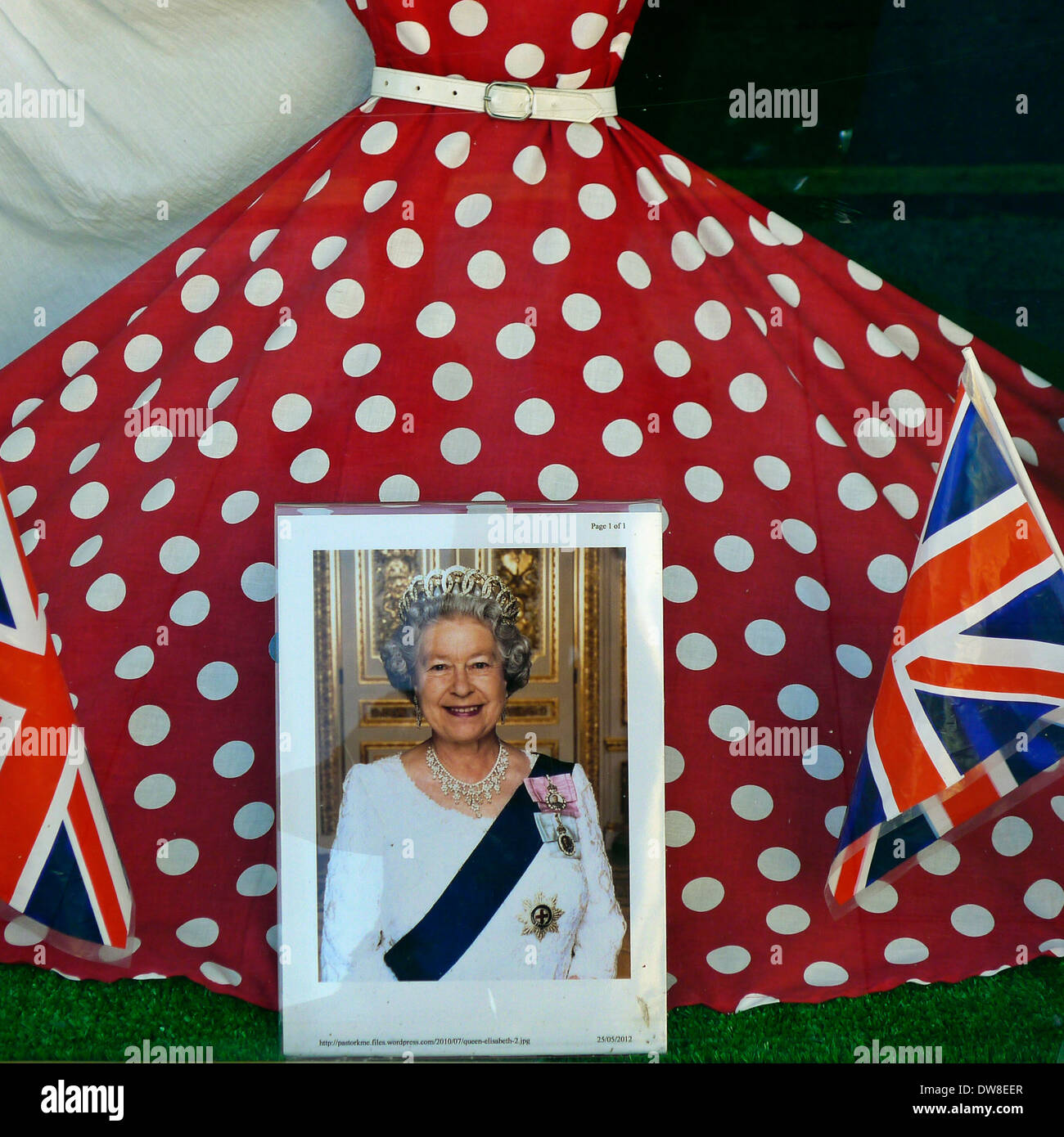 Union flags and photograph of the Queen in font of red spotted dress in ...