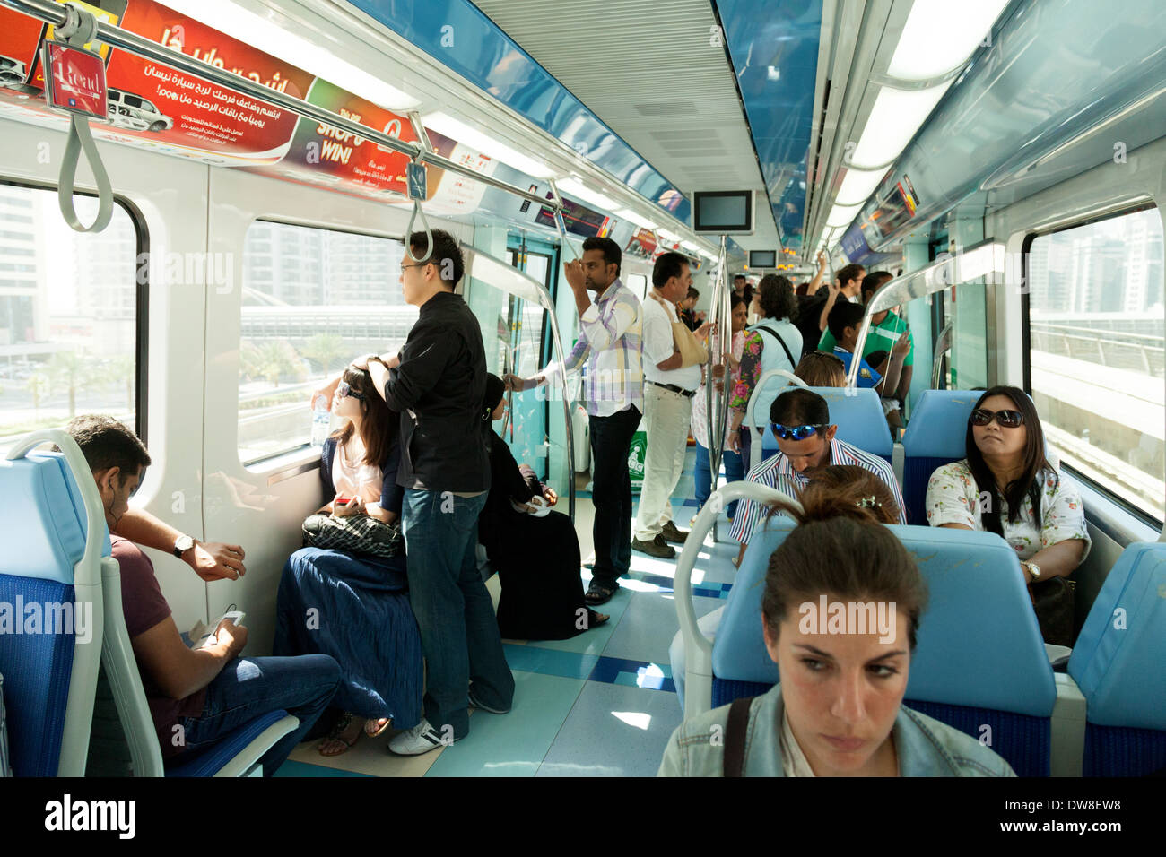 Passengers in a train carriage, the Dubai Metro public transport system ...