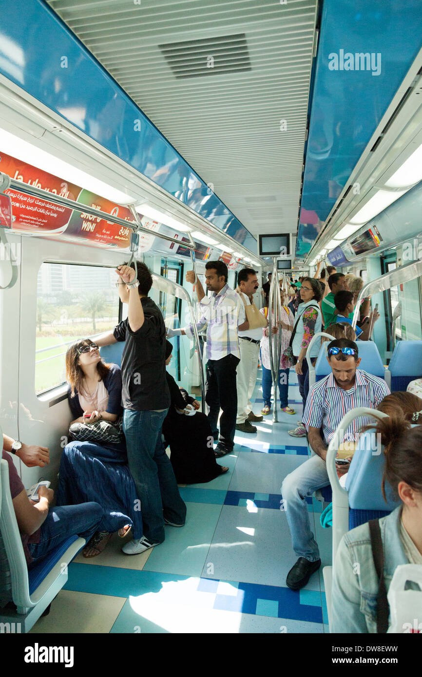 Passengers in a train carriage, the Dubai Metro public transport system ...