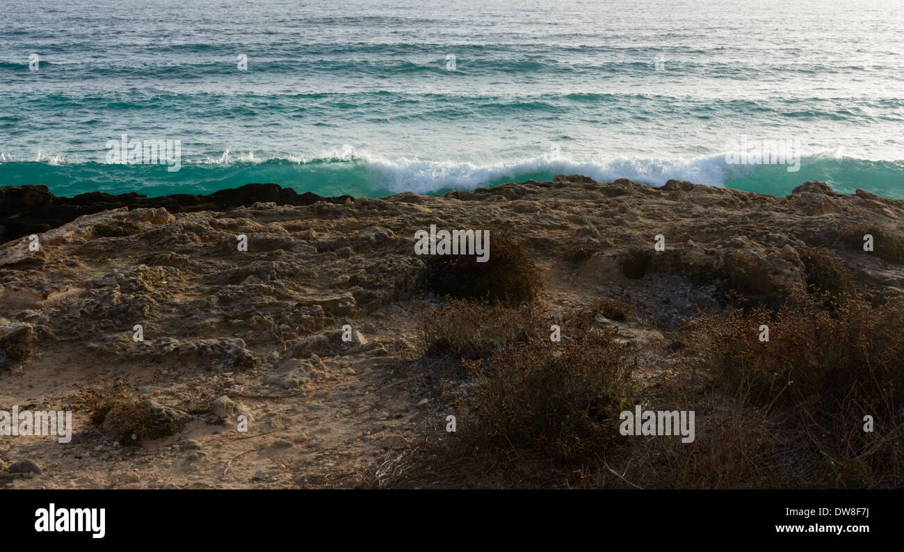 Breaking wave by the rugged coastal limestone rock landscape in Es ...