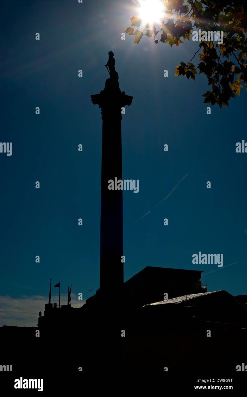 Silhouette Nelsons column Trafalgar square London blue sky sun flare in ...