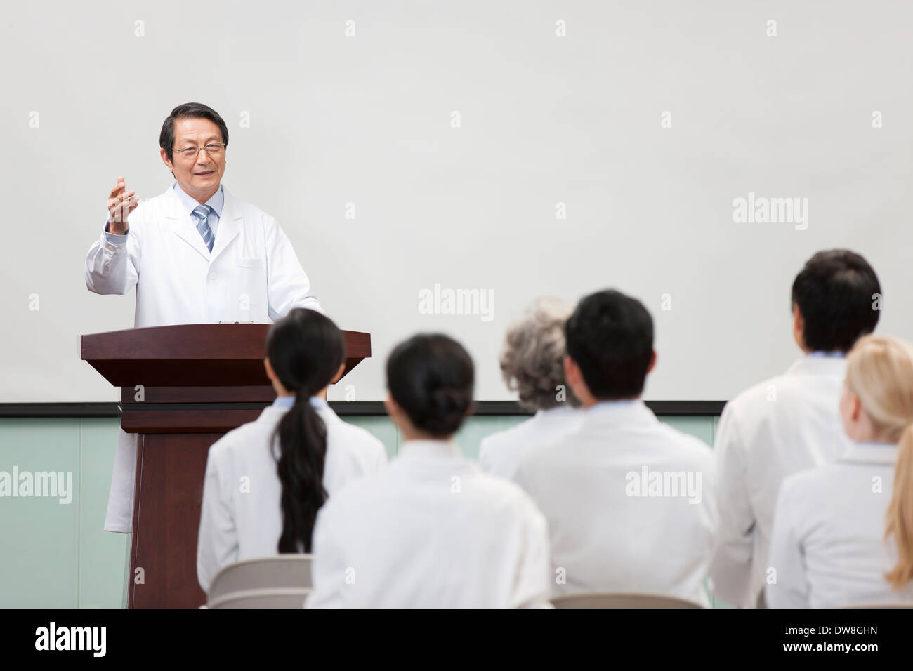 Senior doctor giving speech in boardroom Stock Photo - Alamy