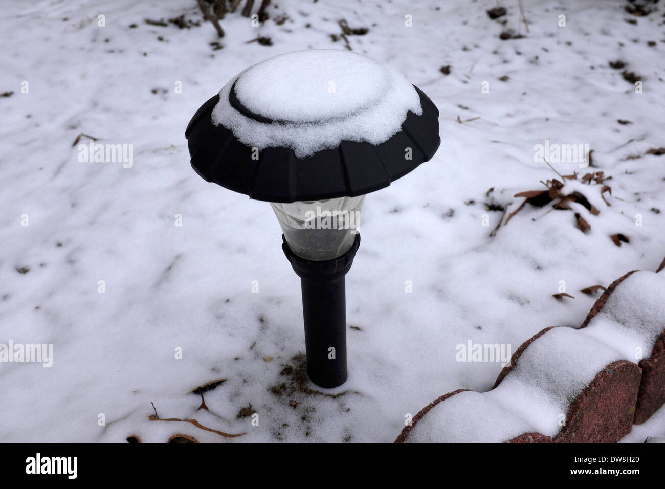 Solar powered light covered in snow Stock Photo - Alamy