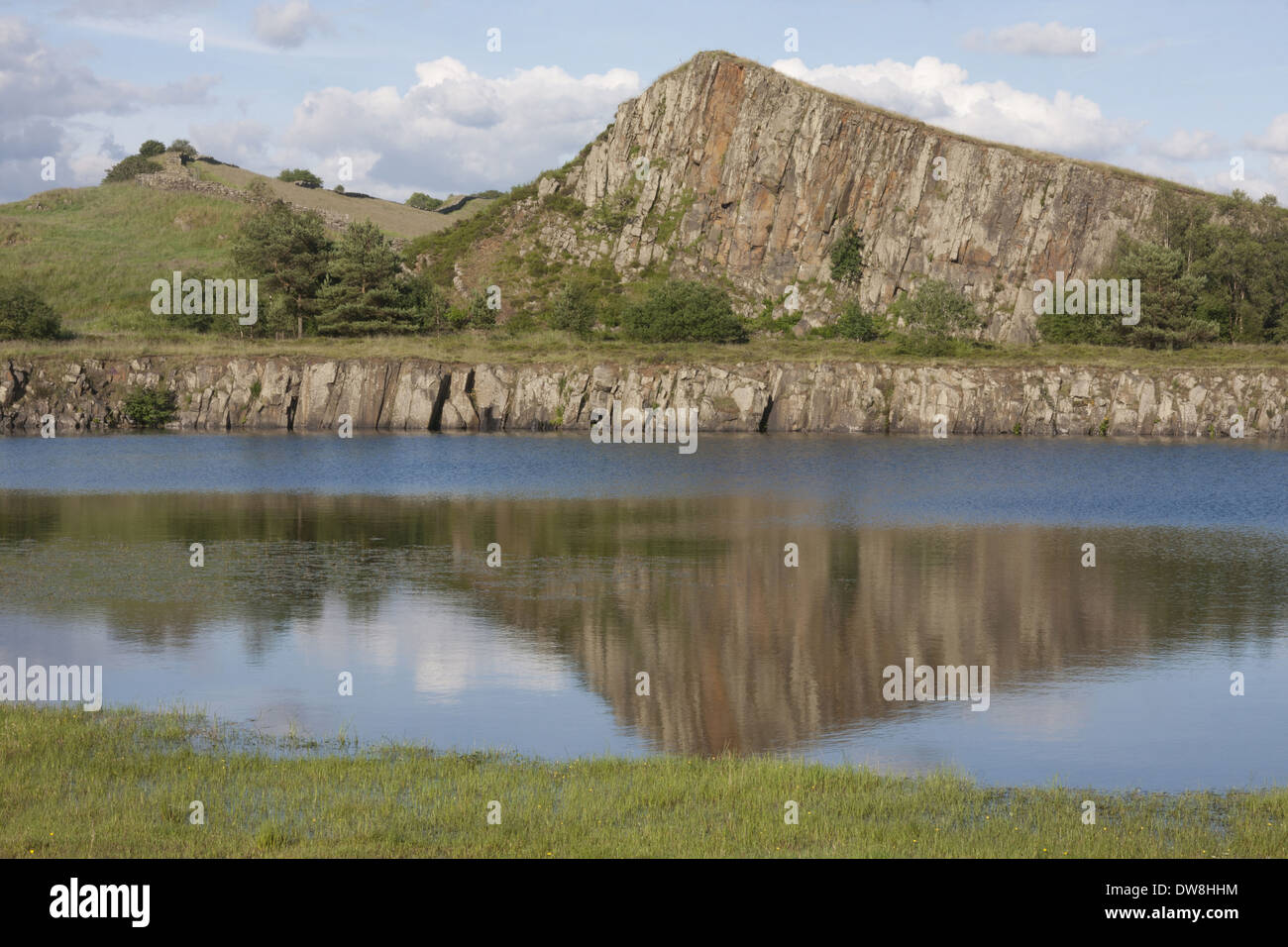 View of flooded former whinstone quarry with exposed rockface Cawfields ...