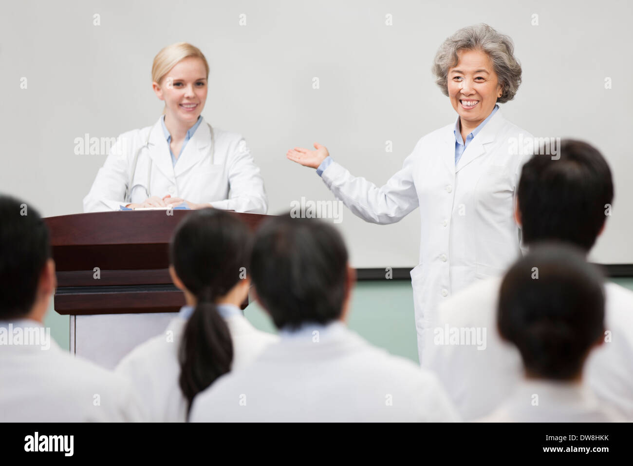 Medical workers giving speech in boardroom Stock Photo - Alamy