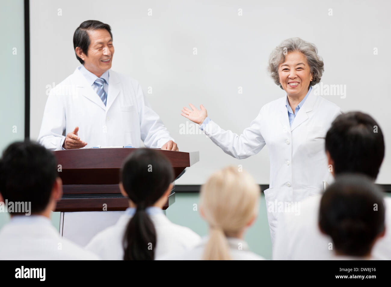 Medical workers giving speech in boardroom Stock Photo - Alamy