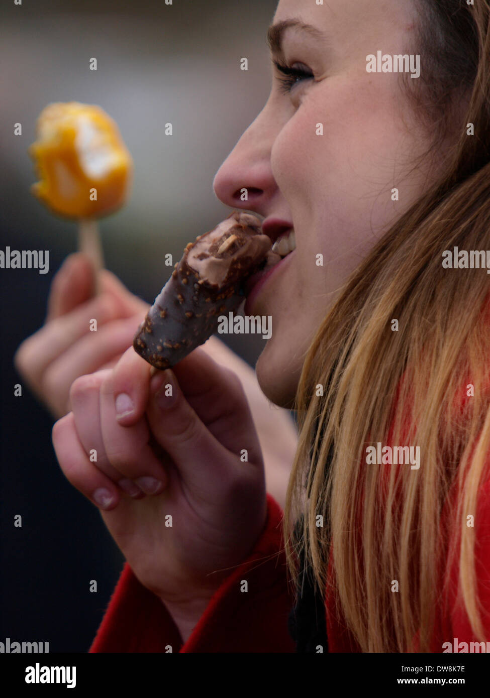Young woman eating an iced lolly Stock Photo - Alamy