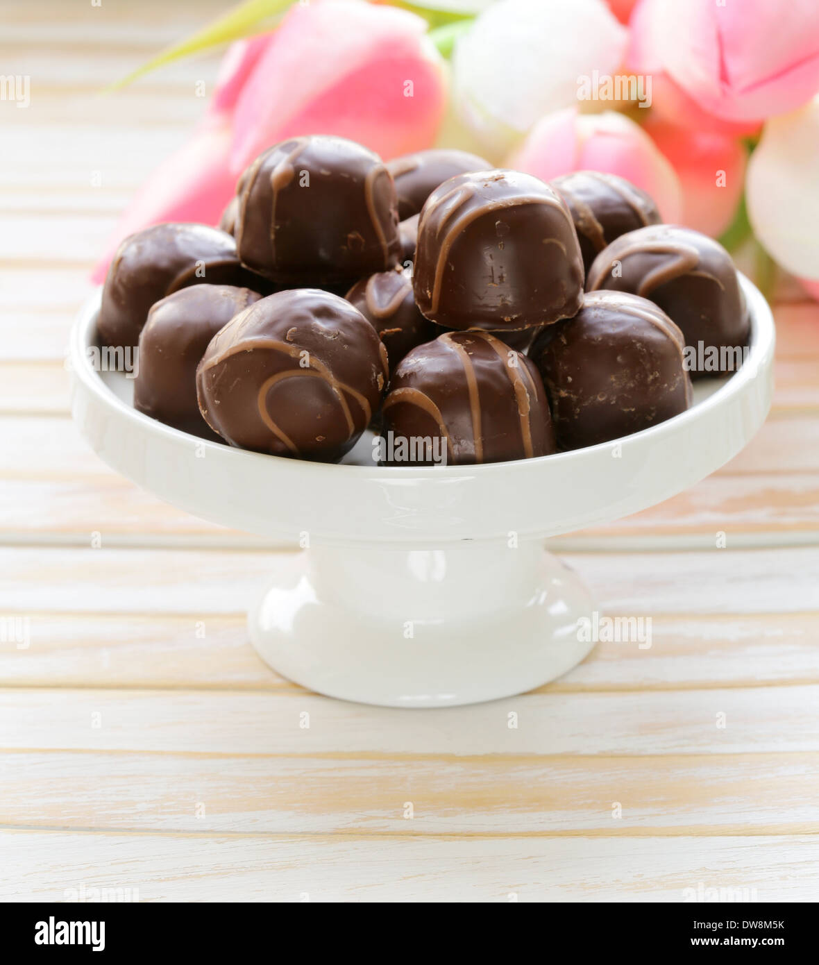 chocolate candy and flowers on white background Stock Photo - Alamy