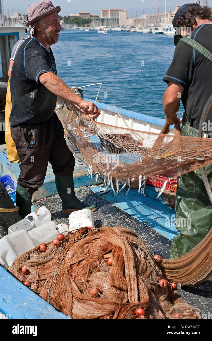 Fishermen on board sorting catch at the fish market in the Old Port of ...