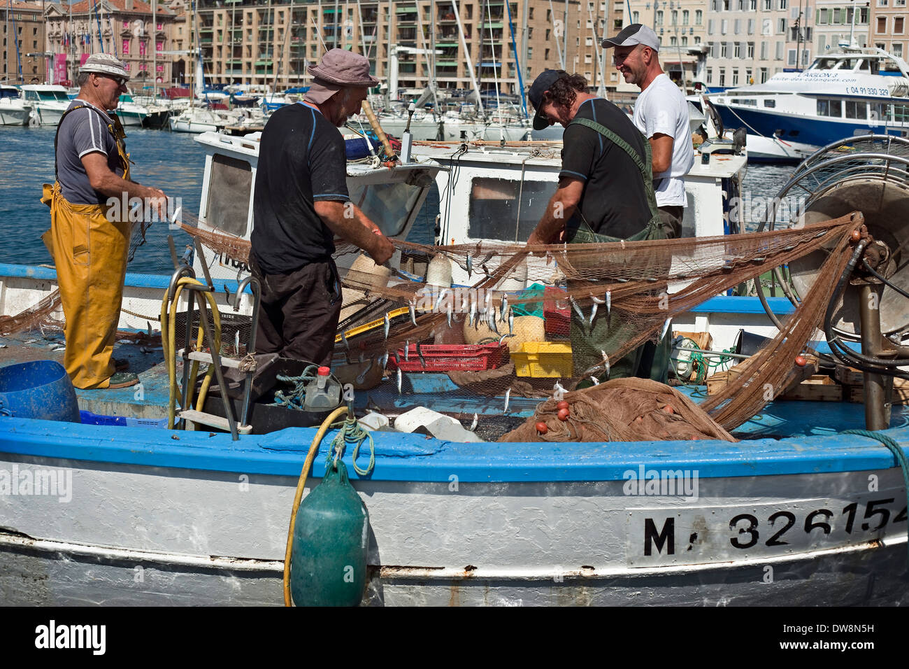 Fishermen on board sorting catch at the fish market in the Old Port of ...