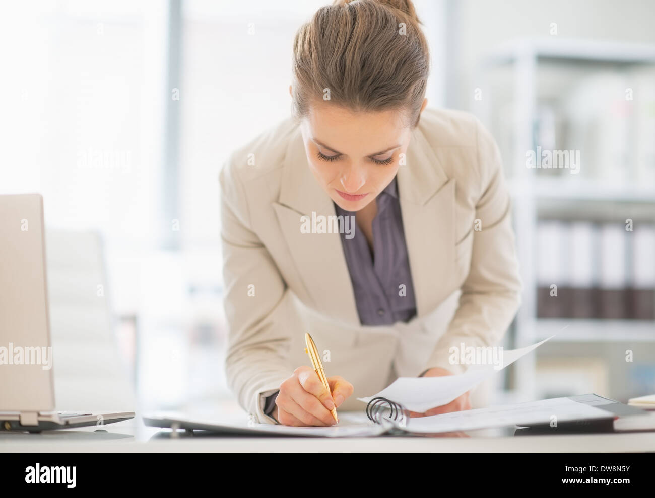 Business woman working in office with documents Stock Photo - Alamy