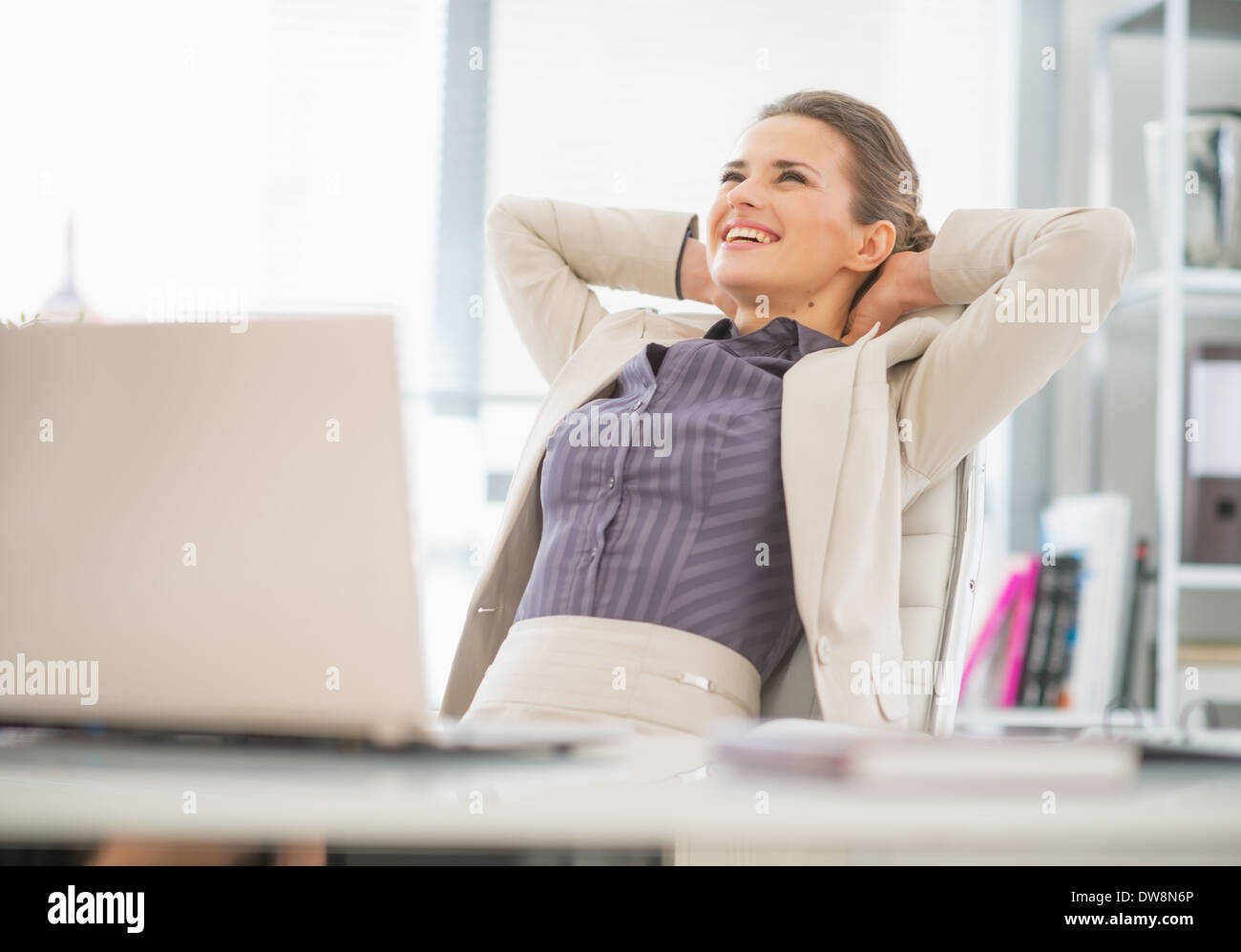 Portrait of relaxed business woman in office Stock Photo - Alamy