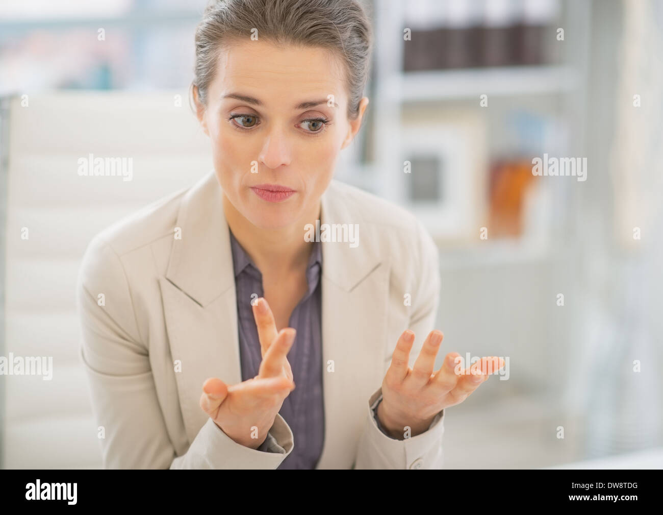 Portrait of business woman in office explaining something Stock Photo ...