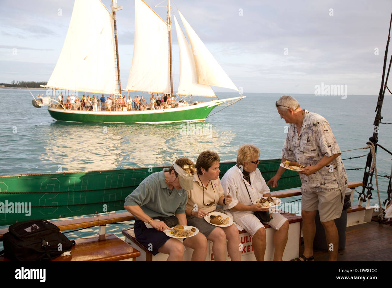 Guests onboard Liberty Clipper enjoy a sunset dinner sail as its marina ...