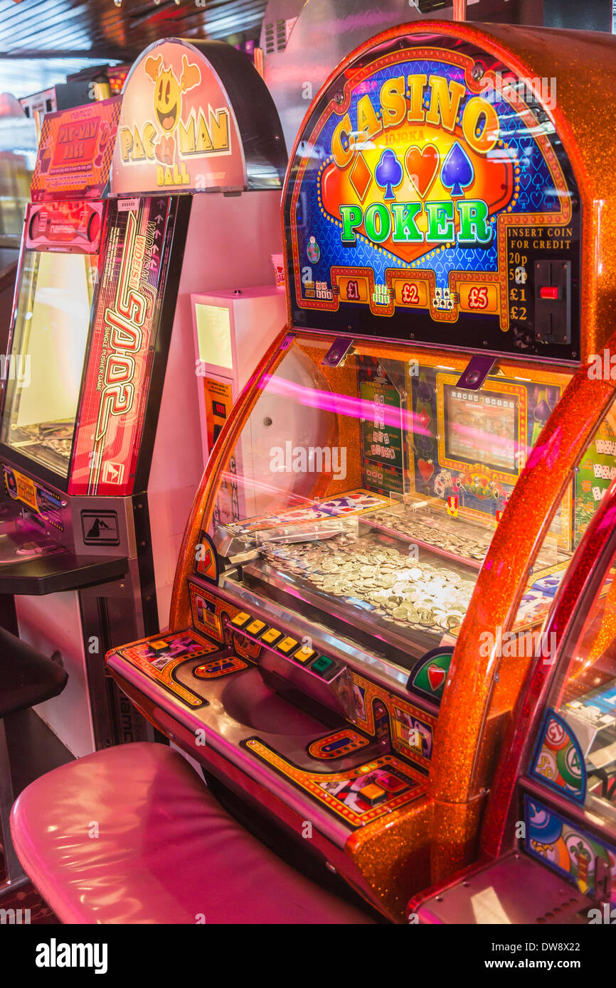 Brightly coloured red slot machine in amusement arcade in Sandown Pier ...