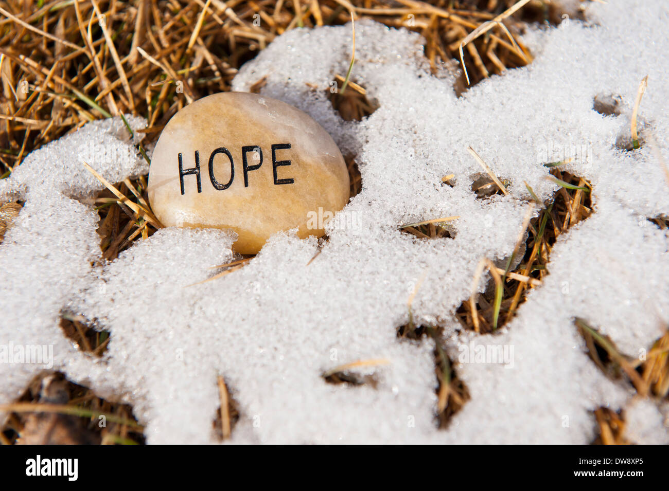 Hope rock in melting snow with the first signs of spring Stock Photo ...