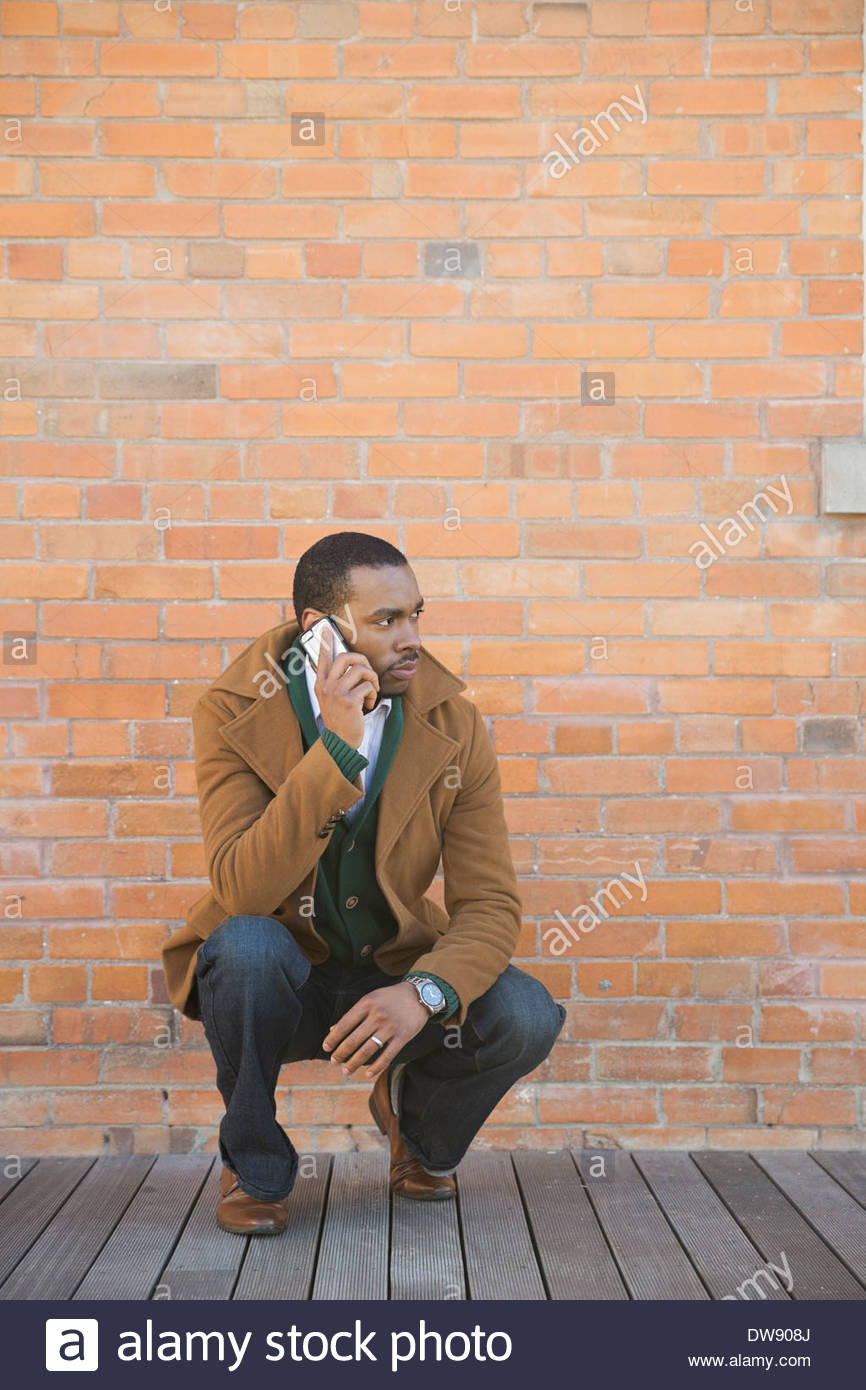 Crouching african man hi-res stock photography and images - Alamy