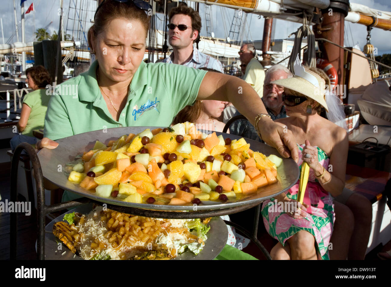 A crew member sets up a buffet for a sunset dinner sail onboard Liberty ...