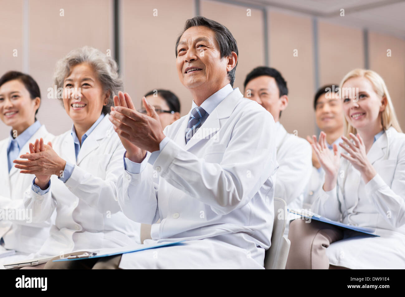 Medical workers clapping in a meeting Stock Photo - Alamy