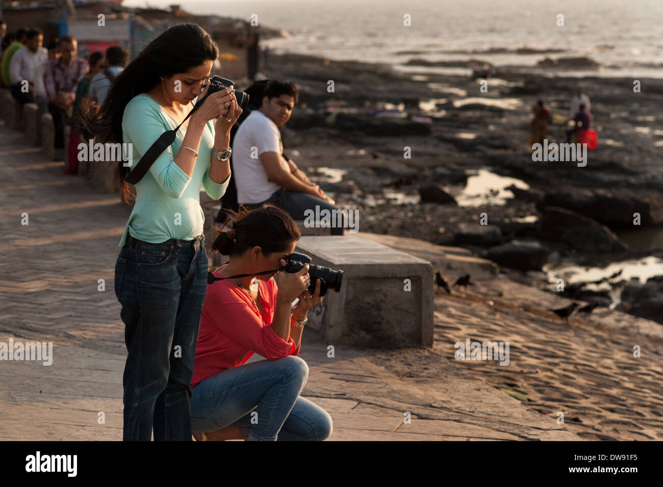 Two attractive young women photographing the beach at Bandstand Bandra ...