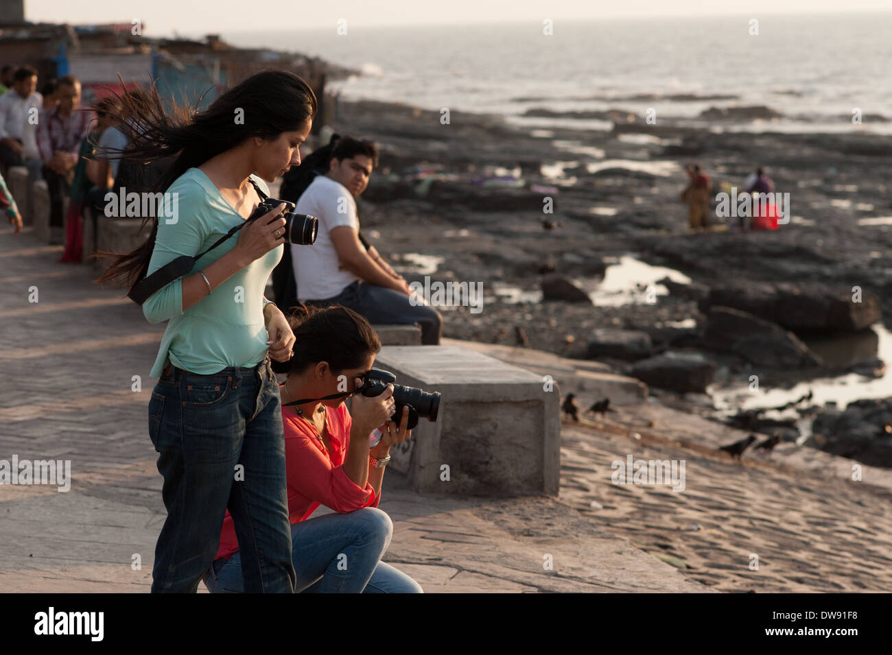 Two attractive young women photographing the beach at Bandstand Bandra ...