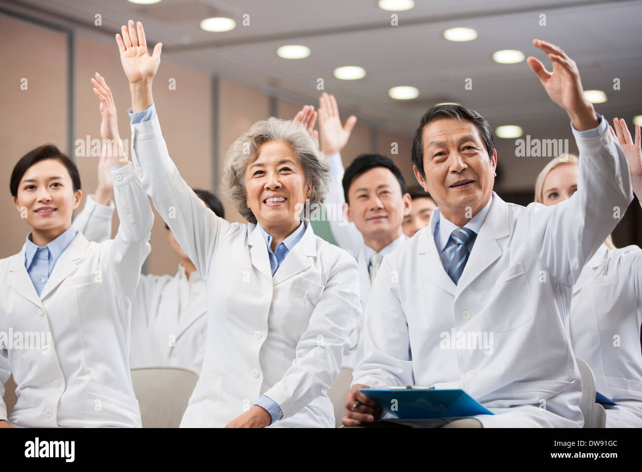 Medical workers raising hands Stock Photo - Alamy