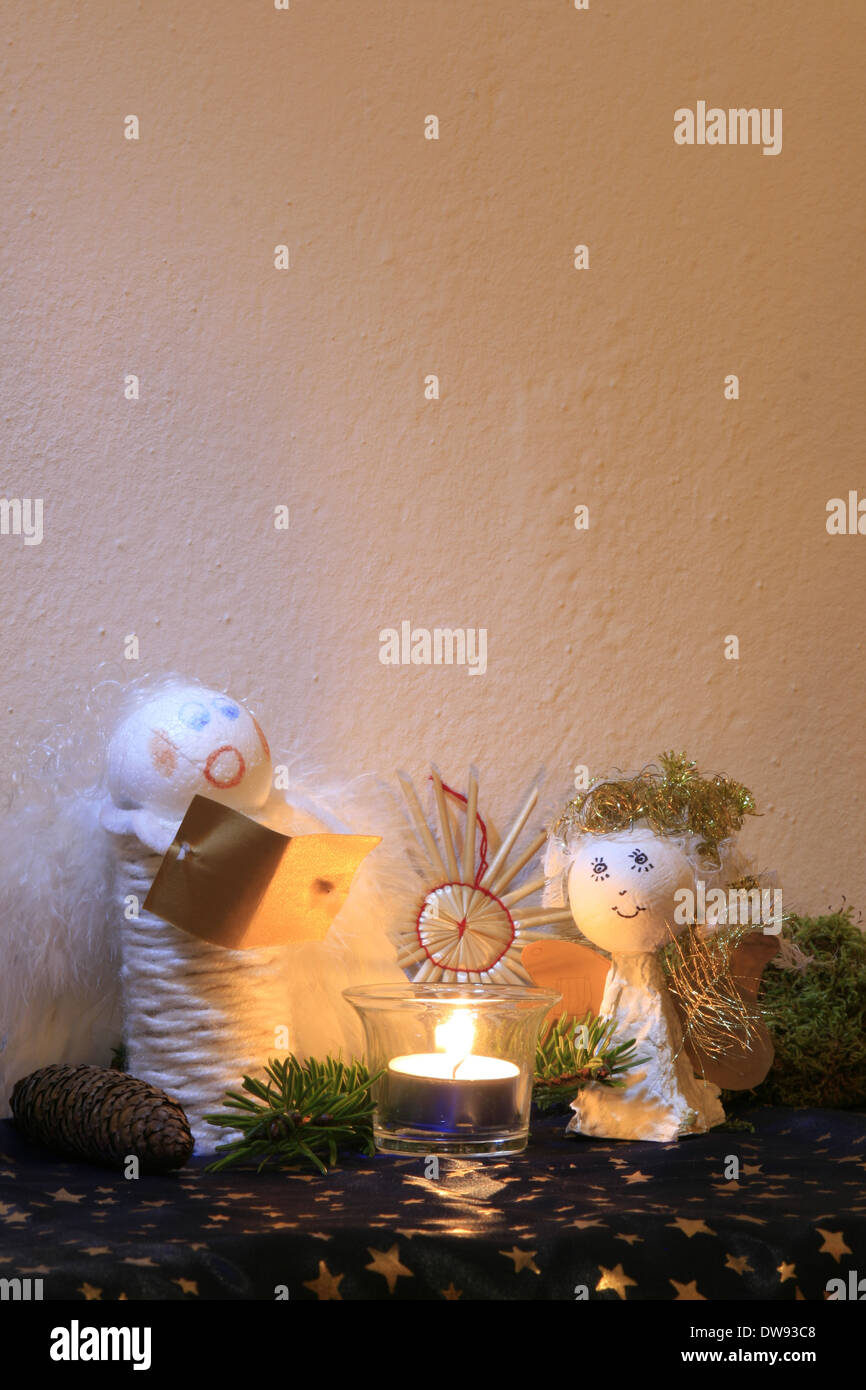 two christmas angles, candle, christmas ceiling, pine braches, moss ...