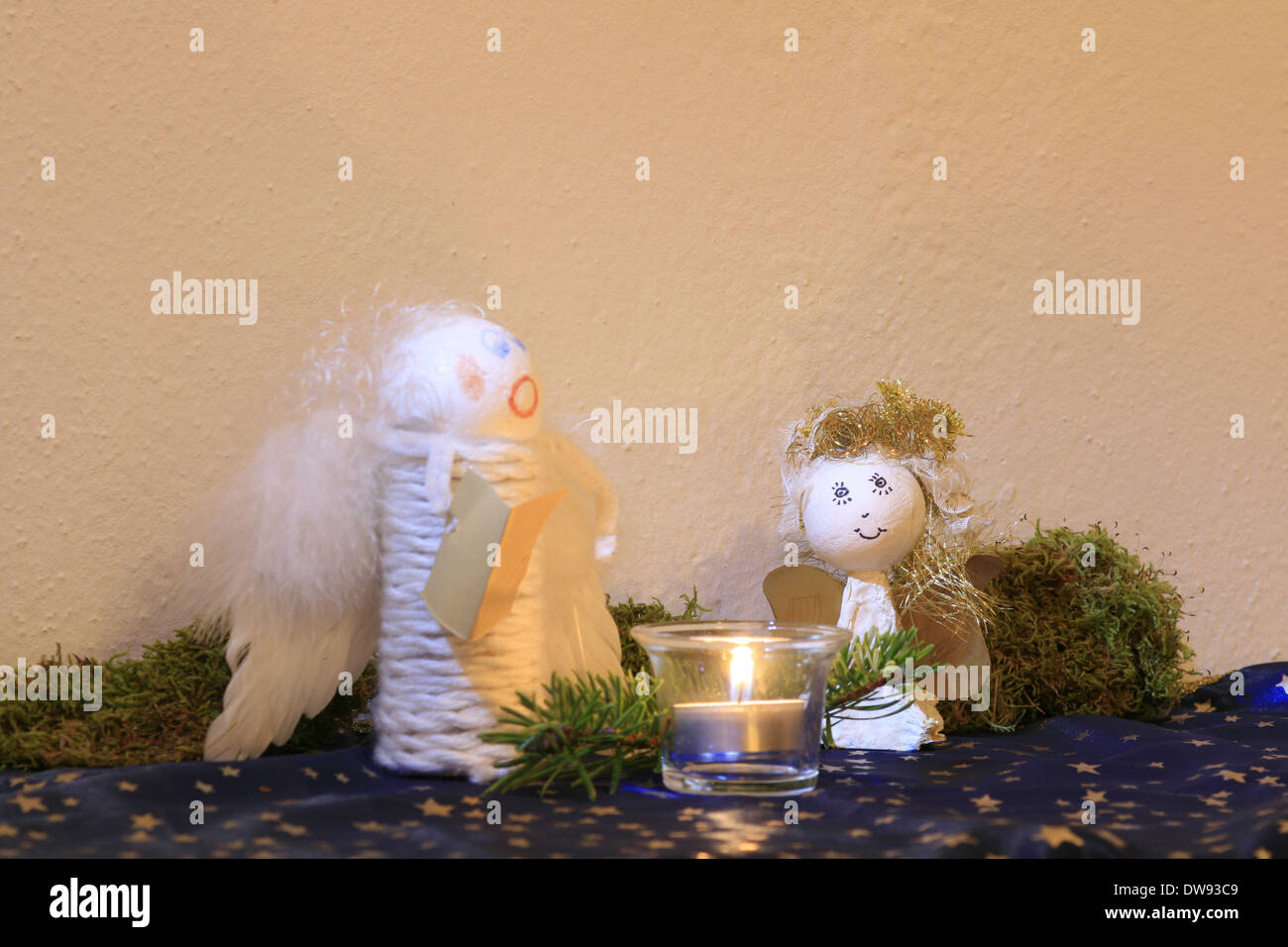 two christmas angles, candle, christmas ceiling, pine braches, moss ...