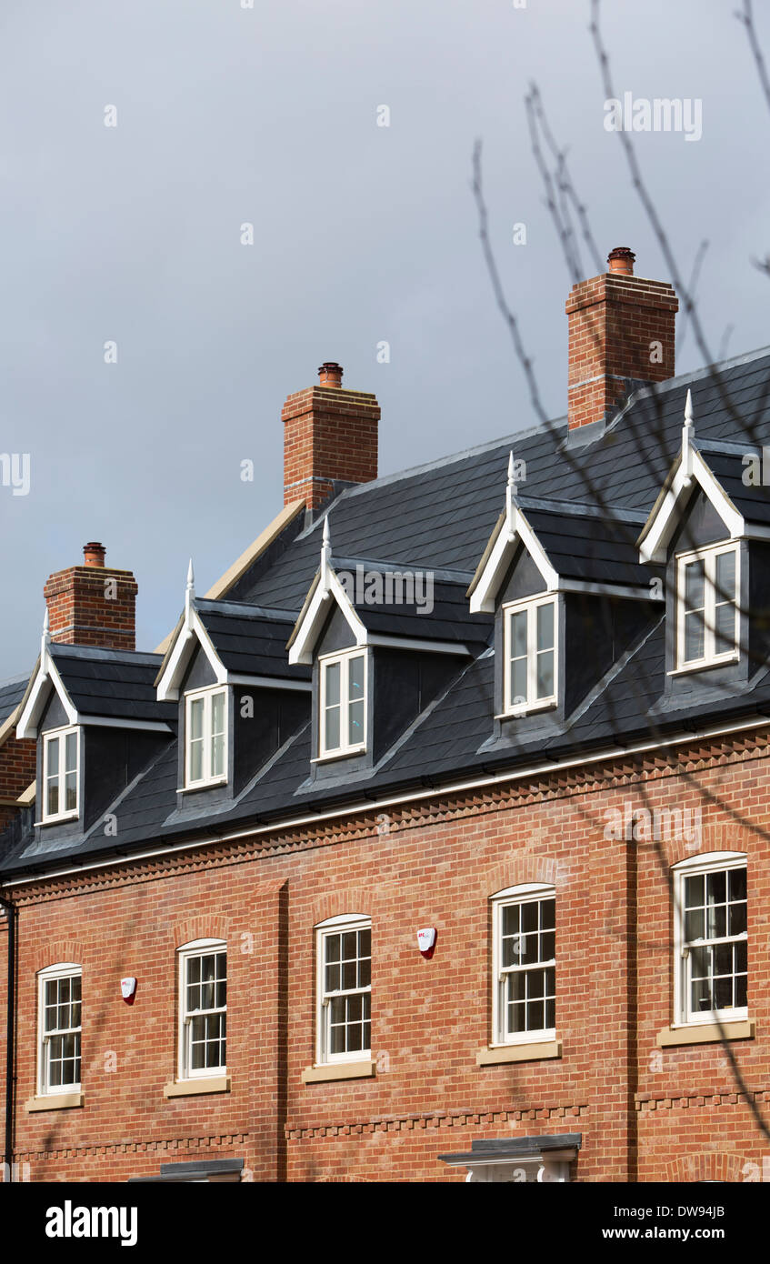 dormer windows on new build houses, slate grey roof and chimneys UK ...