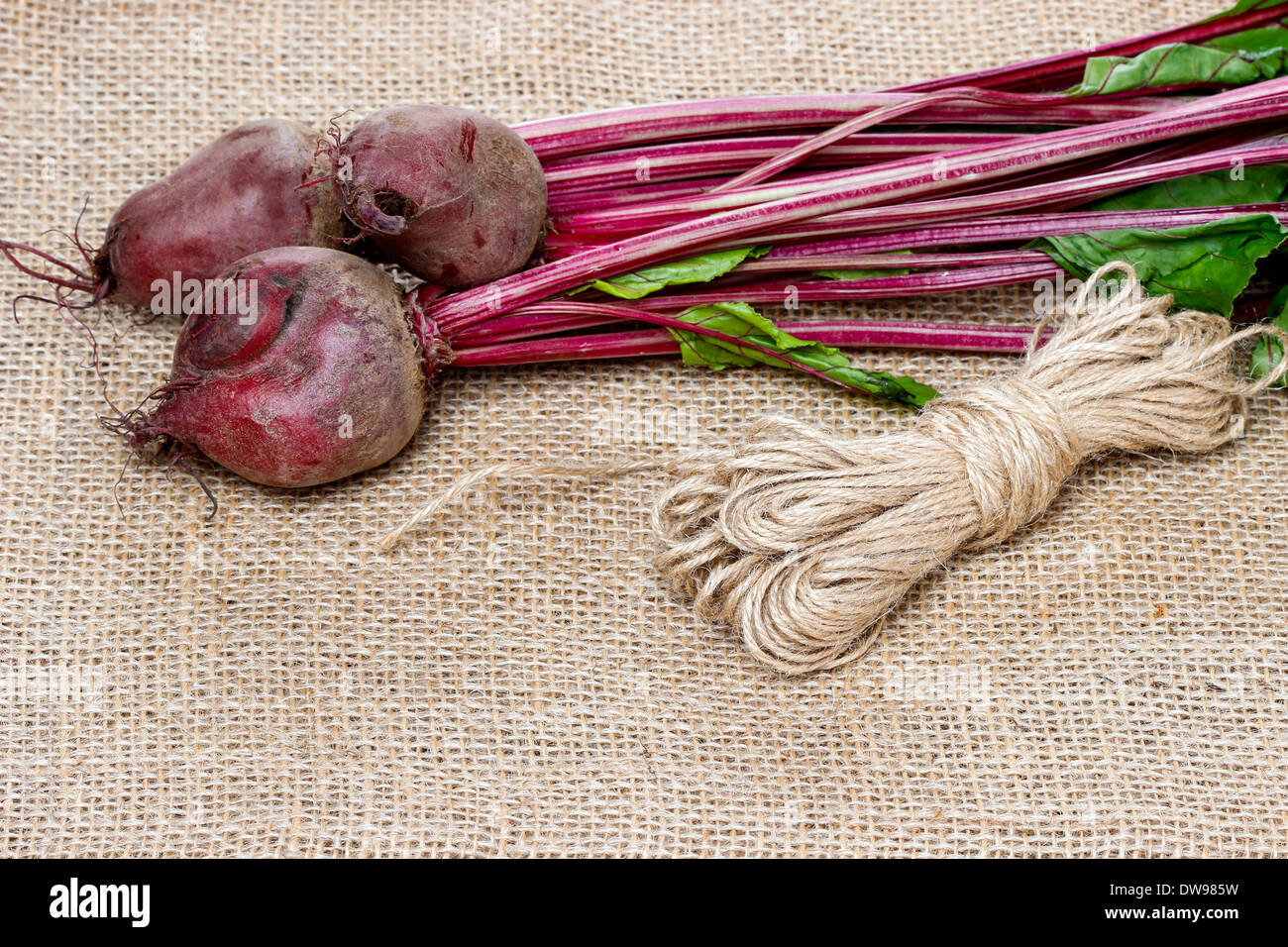 Beetroot on hessian on rustic wooden tableBeetroot on hessian on rustic ...