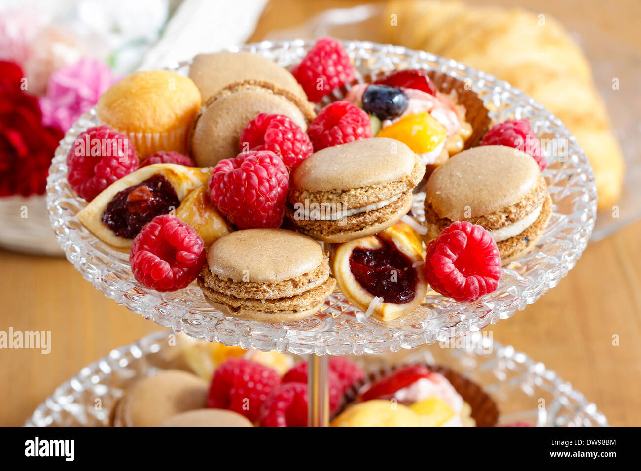 Two level dessert stand full of sweetsTwo level dessert stand full of ...