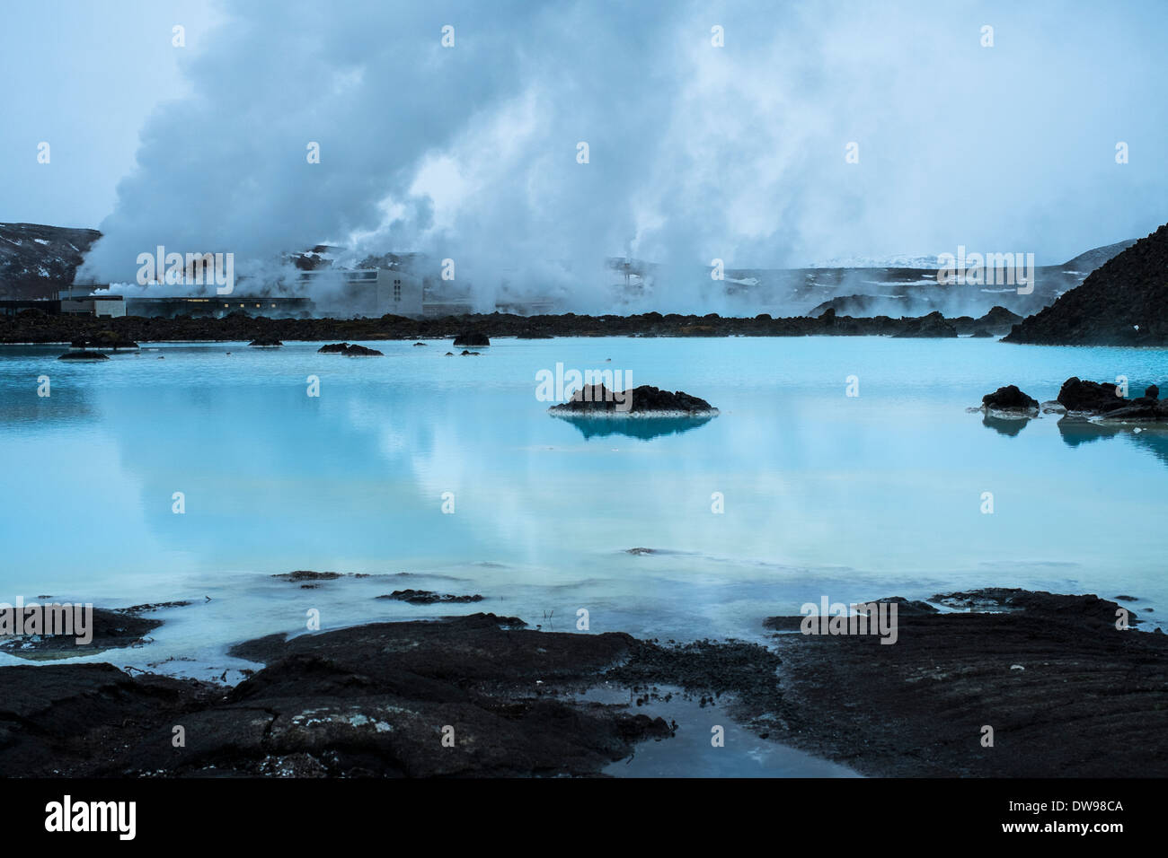Steam hangs over the blue water from the thermal ponds created by the ...