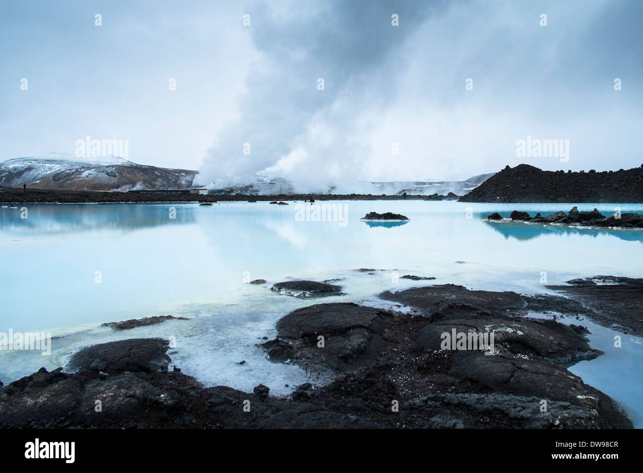 Steam hangs over the blue water from the thermal ponds created by the ...