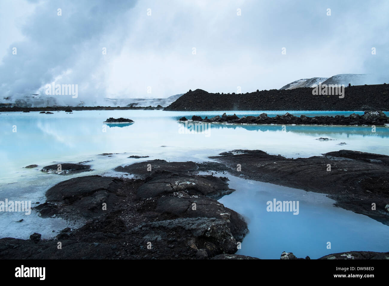 Steam hangs over the blue water from the thermal ponds created by the ...