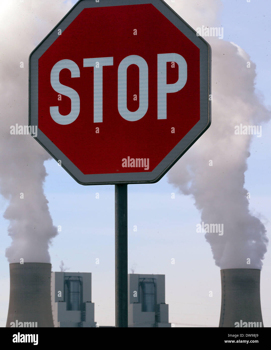 Steam rises from the lignite power plant Neurath II behind a stop sign ...
