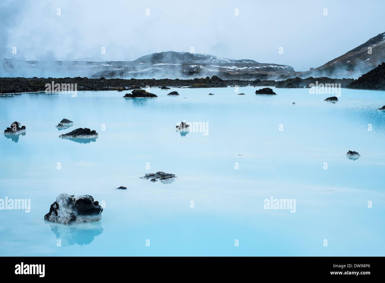 Steam hangs over the blue water from the thermal ponds created by the ...