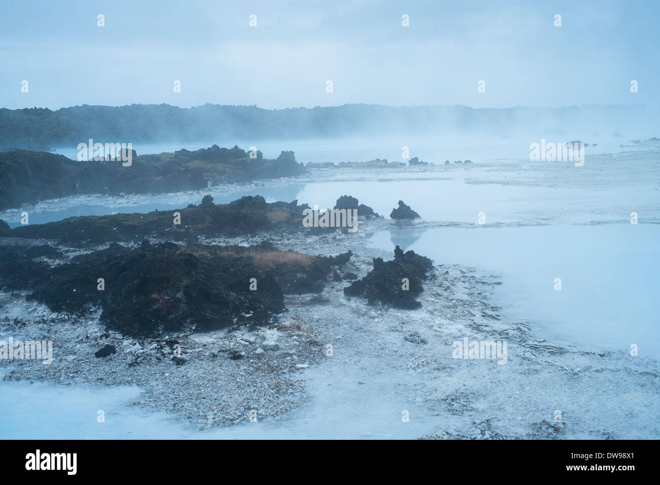 Steam hangs over the blue water from the thermal ponds created by the ...