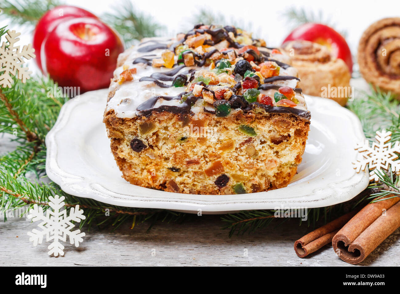 Fruitcake with dried fruits and nuts in christmas settingFruitcake with ...