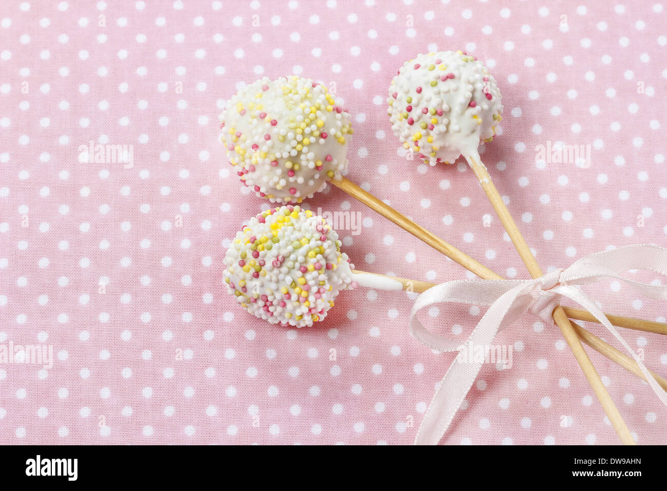 White cake pops on pink dotted backgroundWhite cake pops on pink dotted ...