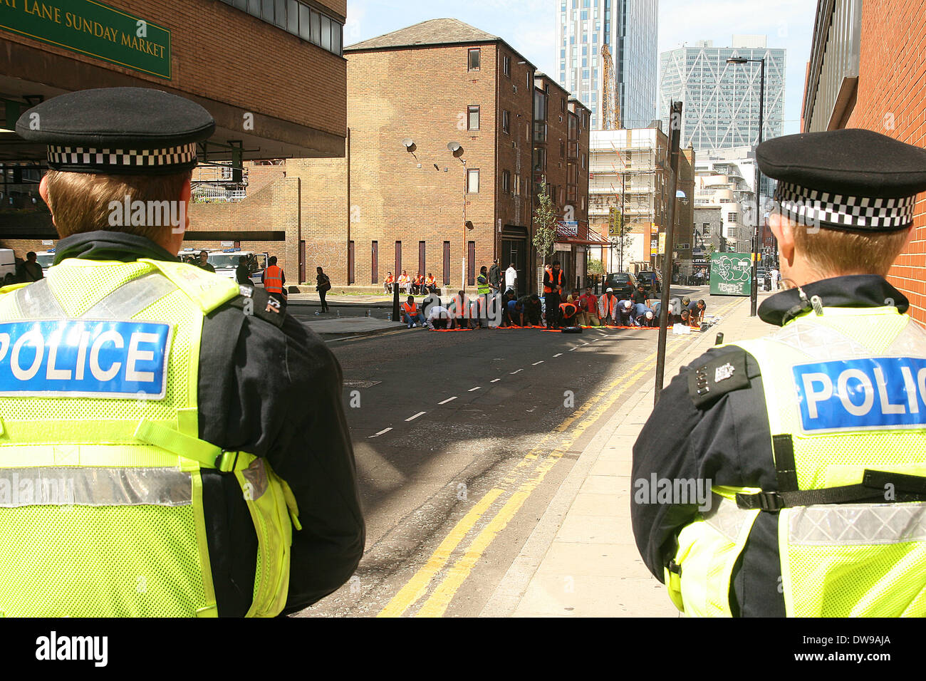 Members of the Muslim faith pray in front of riot police in Tower ...