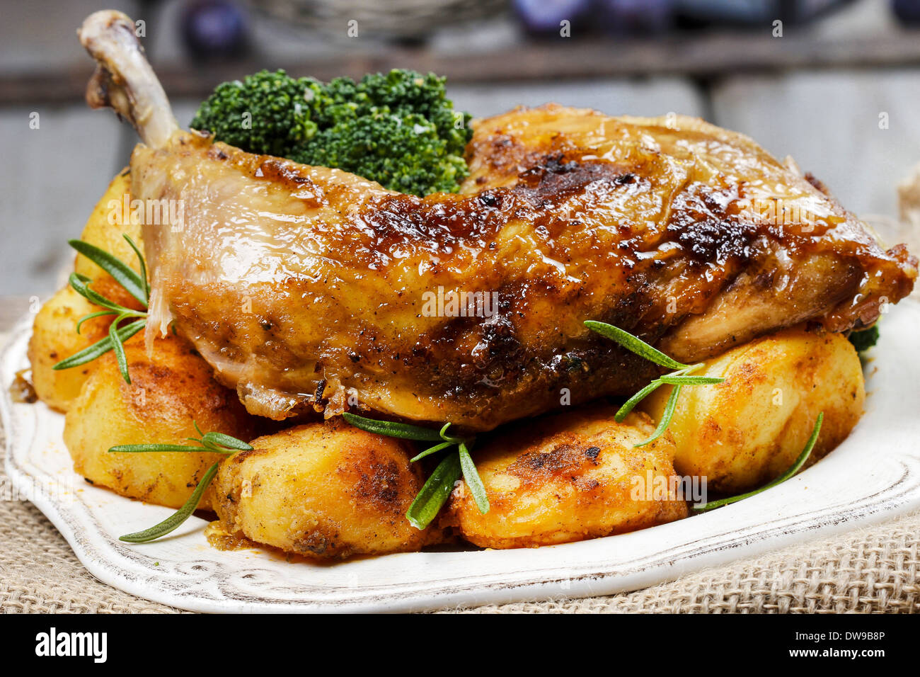 Roasted chicken with vegetables on wooden tableRoasted chicken with ...