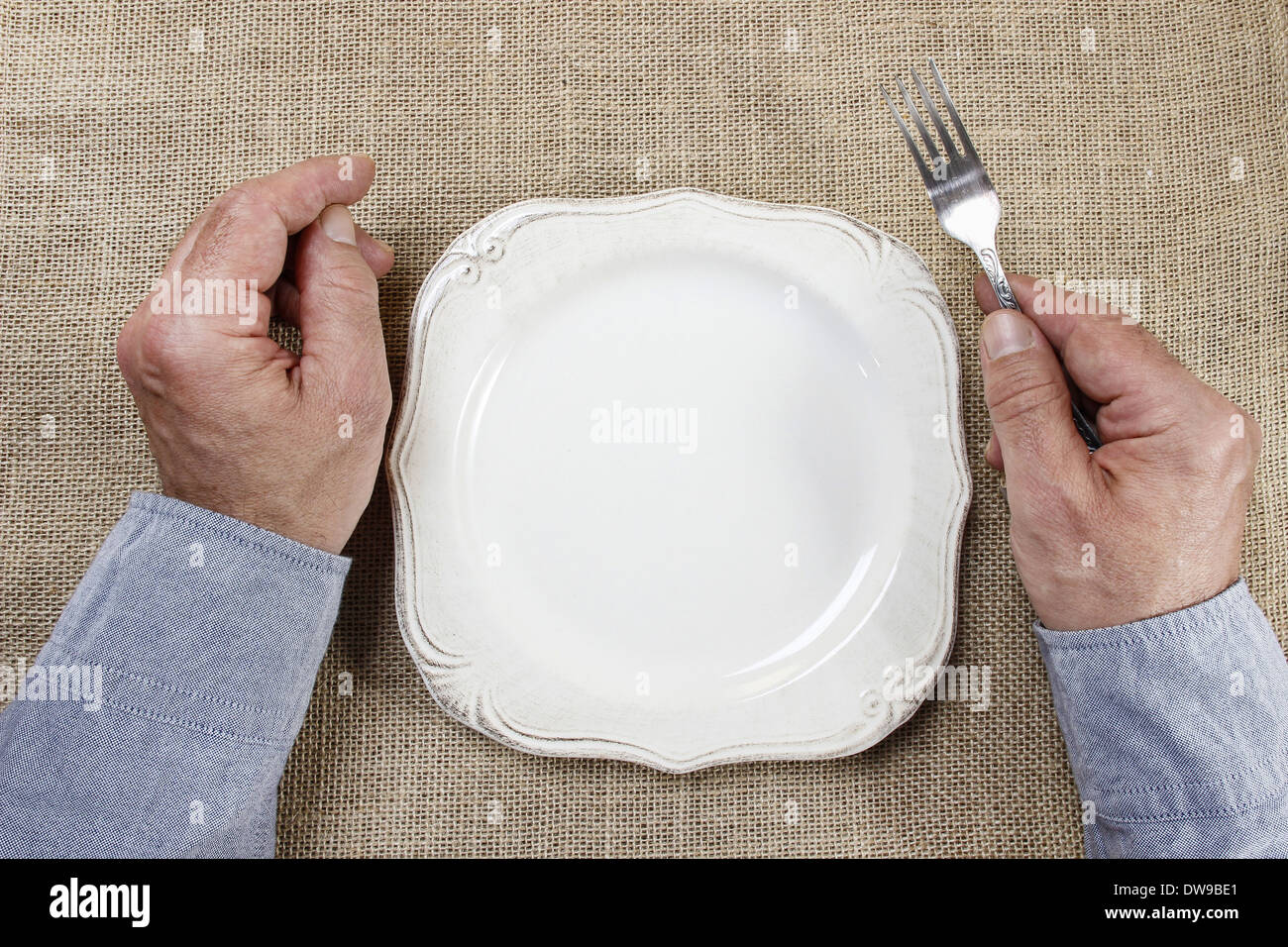 Top view of hungry man over empty plate Stock Photo - Alamy