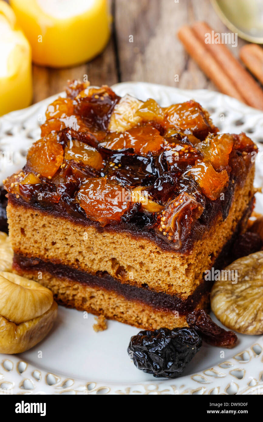 Delicious layer gingerbread cake decorated with dried fruitsDelicious ...