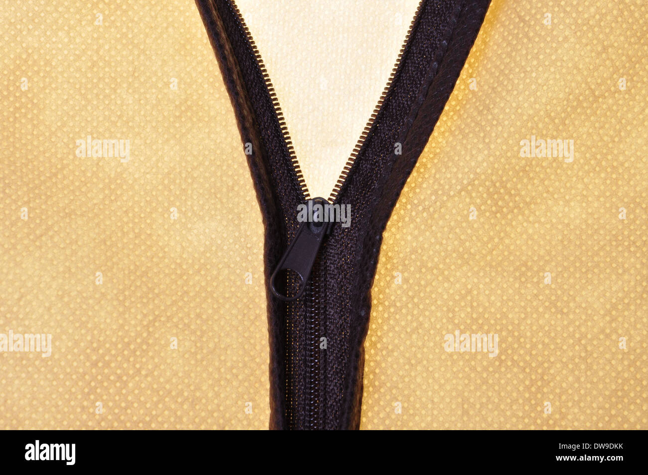 Brown zipper bag in beige cover Stock Photo - Alamy