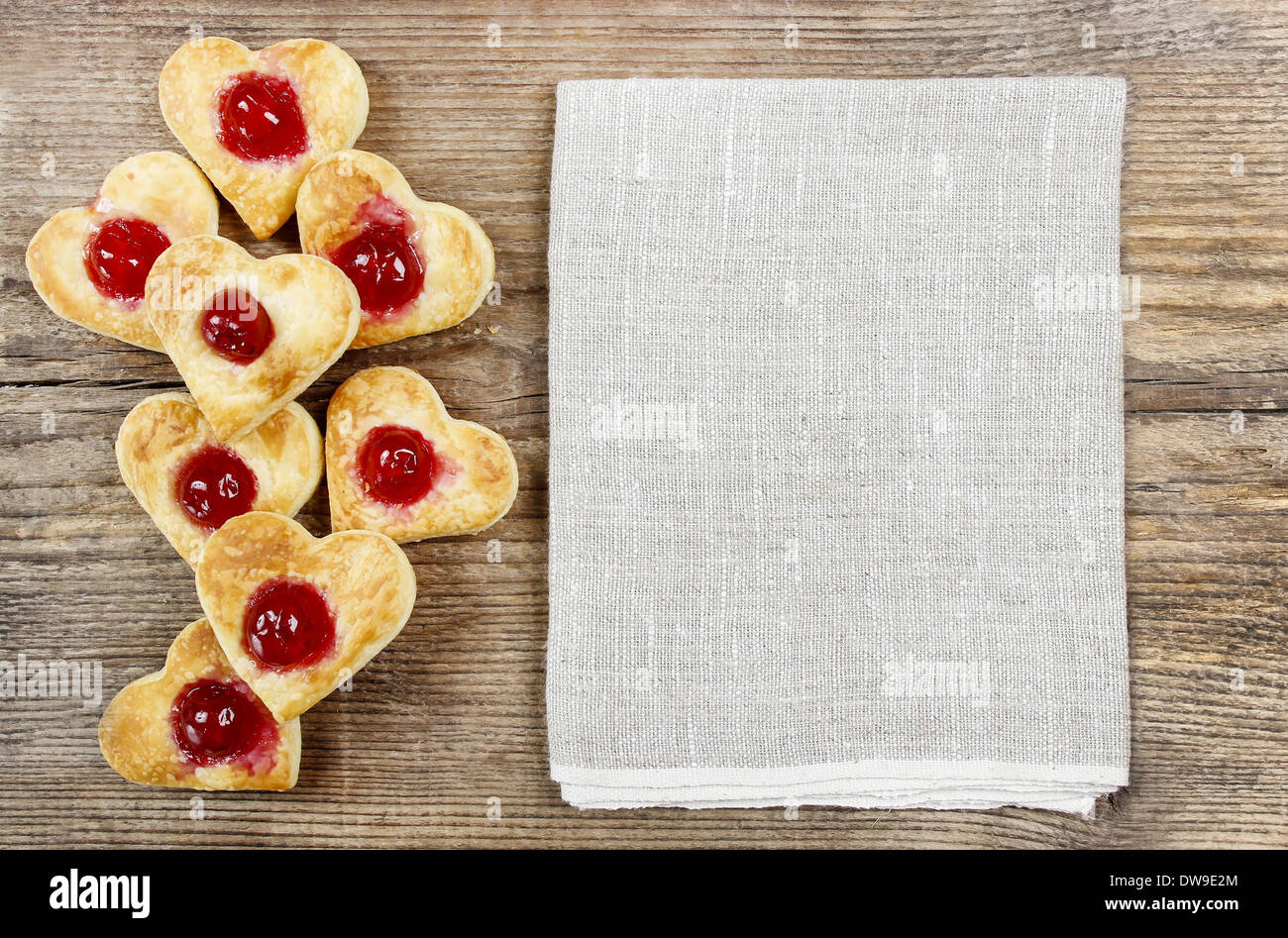 Puff pastry cookies in heart shape filled with cherriesPuff pastry ...
