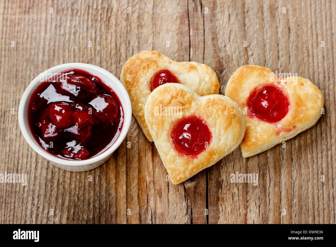 Puff pastry cookies in heart shape filled with cherriesPuff pastry ...