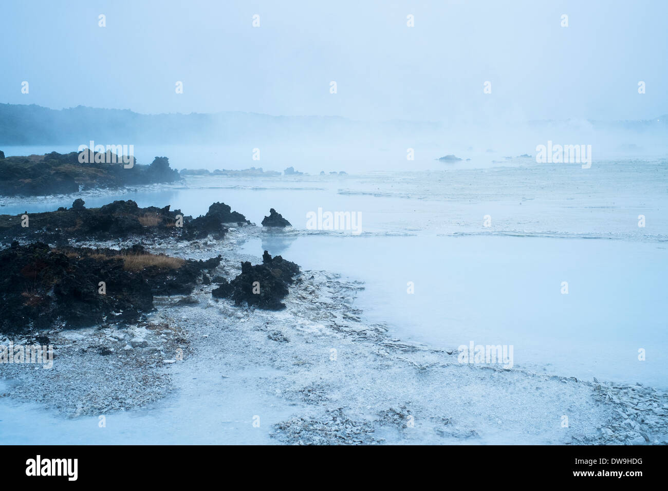 Steam hangs over the blue water from the thermal ponds created by the ...