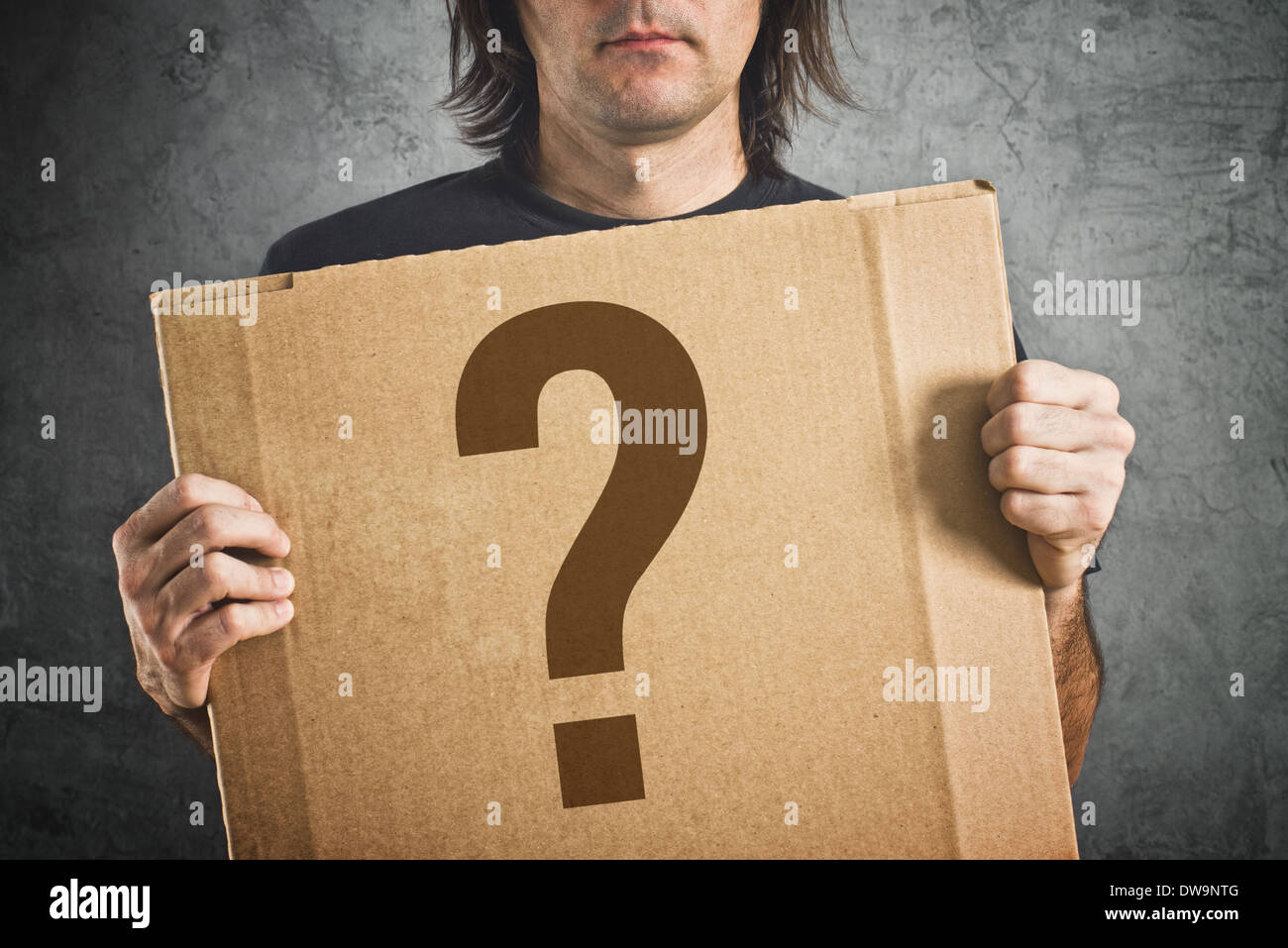 Man holding cardboard poster with question mark printed on Stock Photo ...