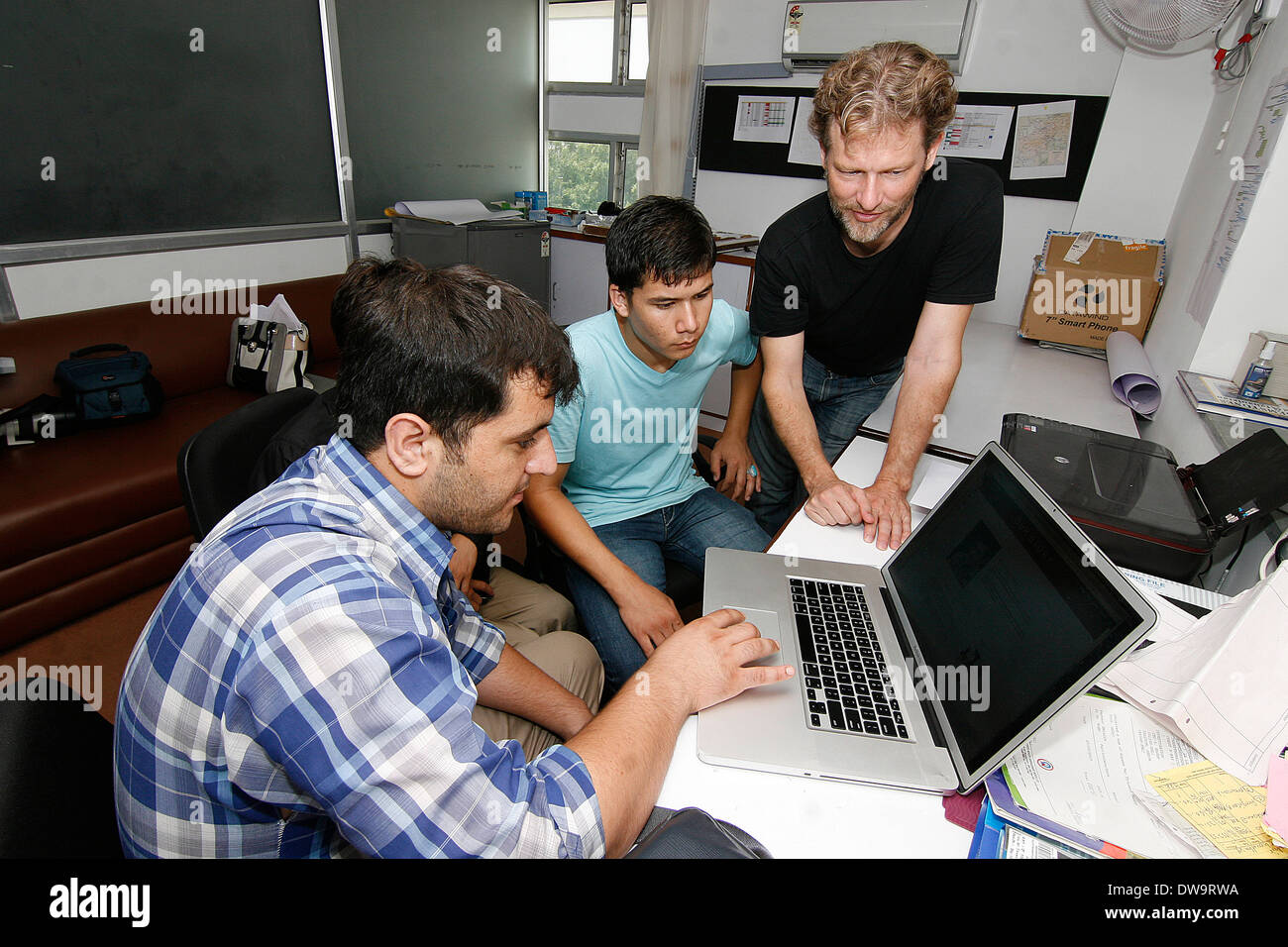 Afghan students learning to use a laptop computer Stock Photo - Alamy