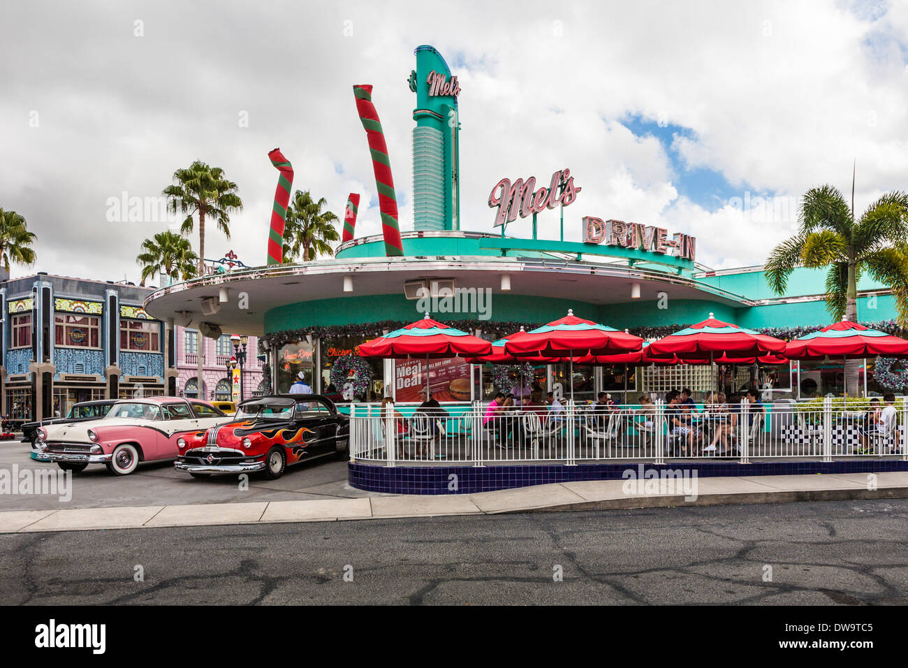 Antique cars and umbrella covered outdoor tables at Mel's Drive-In in ...